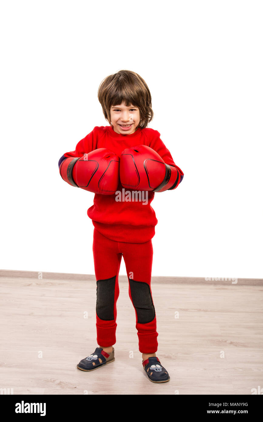 Strong little boy showing fists in boxing gloves against white ...