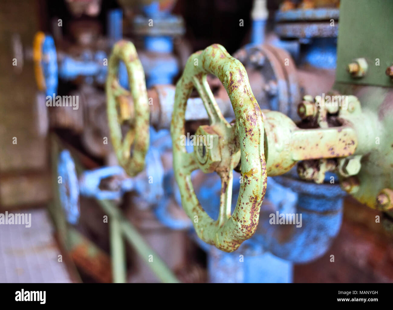 Old industry valve and pipes. Rusty rotary valve and pipes in an ...