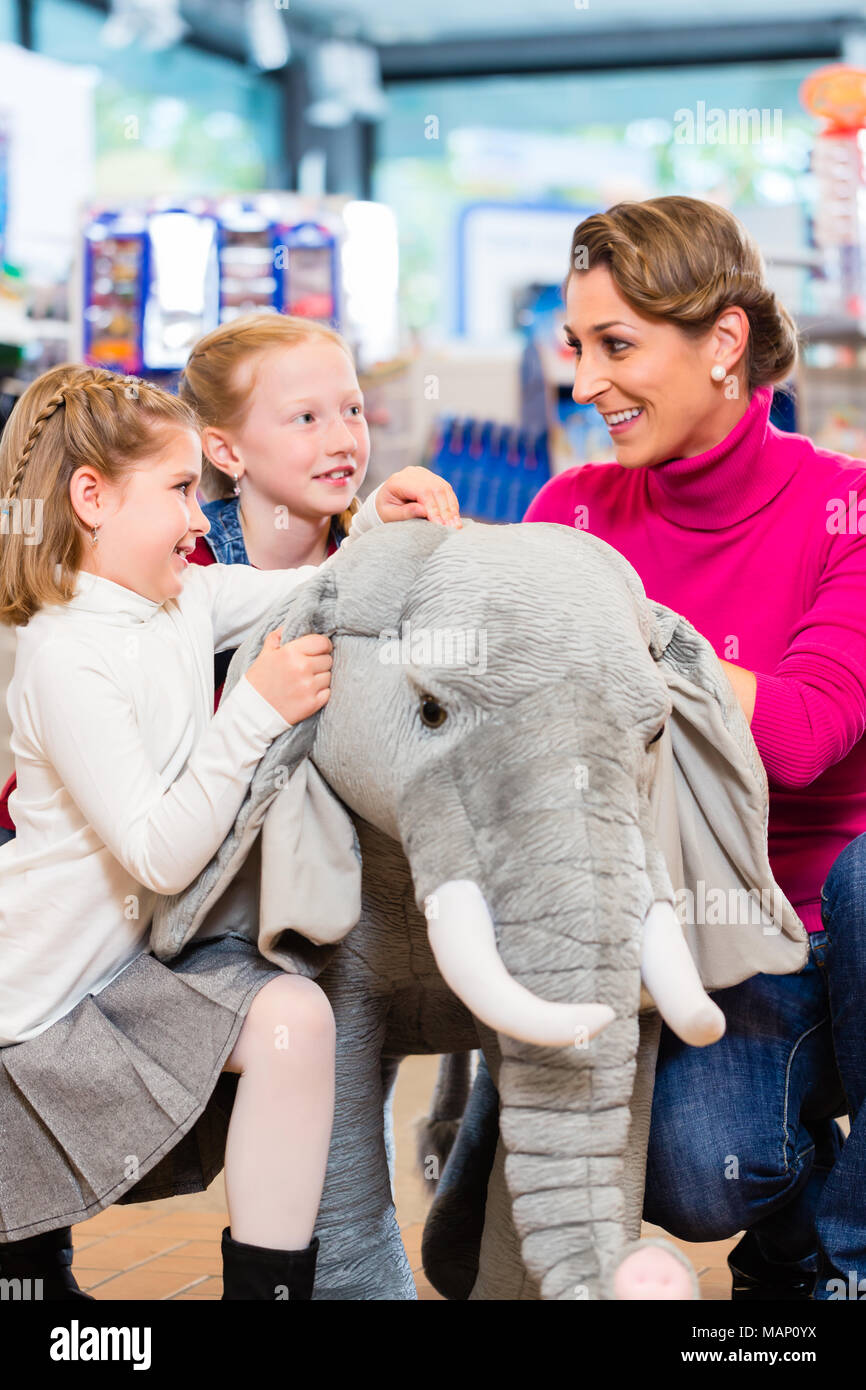 Family in toy store cuddling with stuffed animal Stock Photo - Alamy