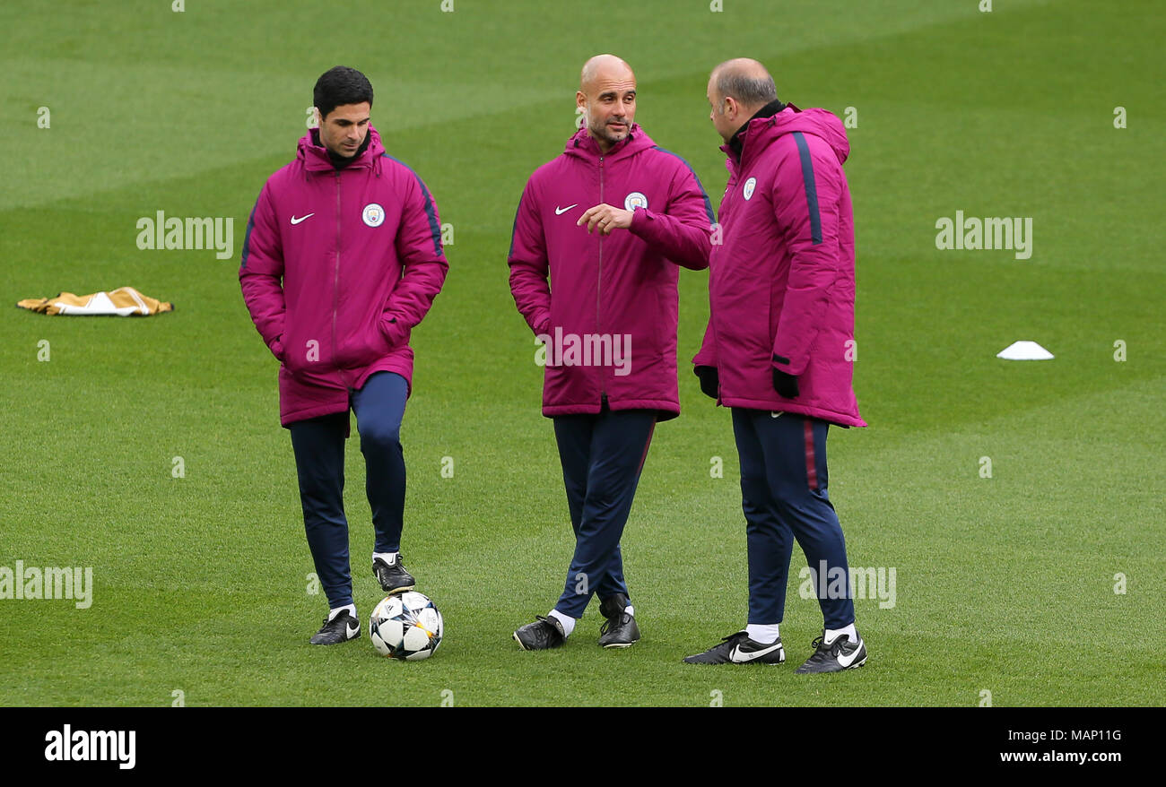 Manchester City manager Pep Guardiola speaks to his coaching staff ...
