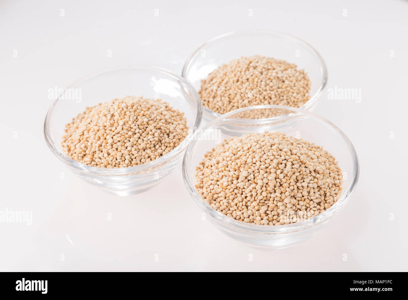 Quinoa grains in bowl isolated on white background, Chenopodium quinoa ...
