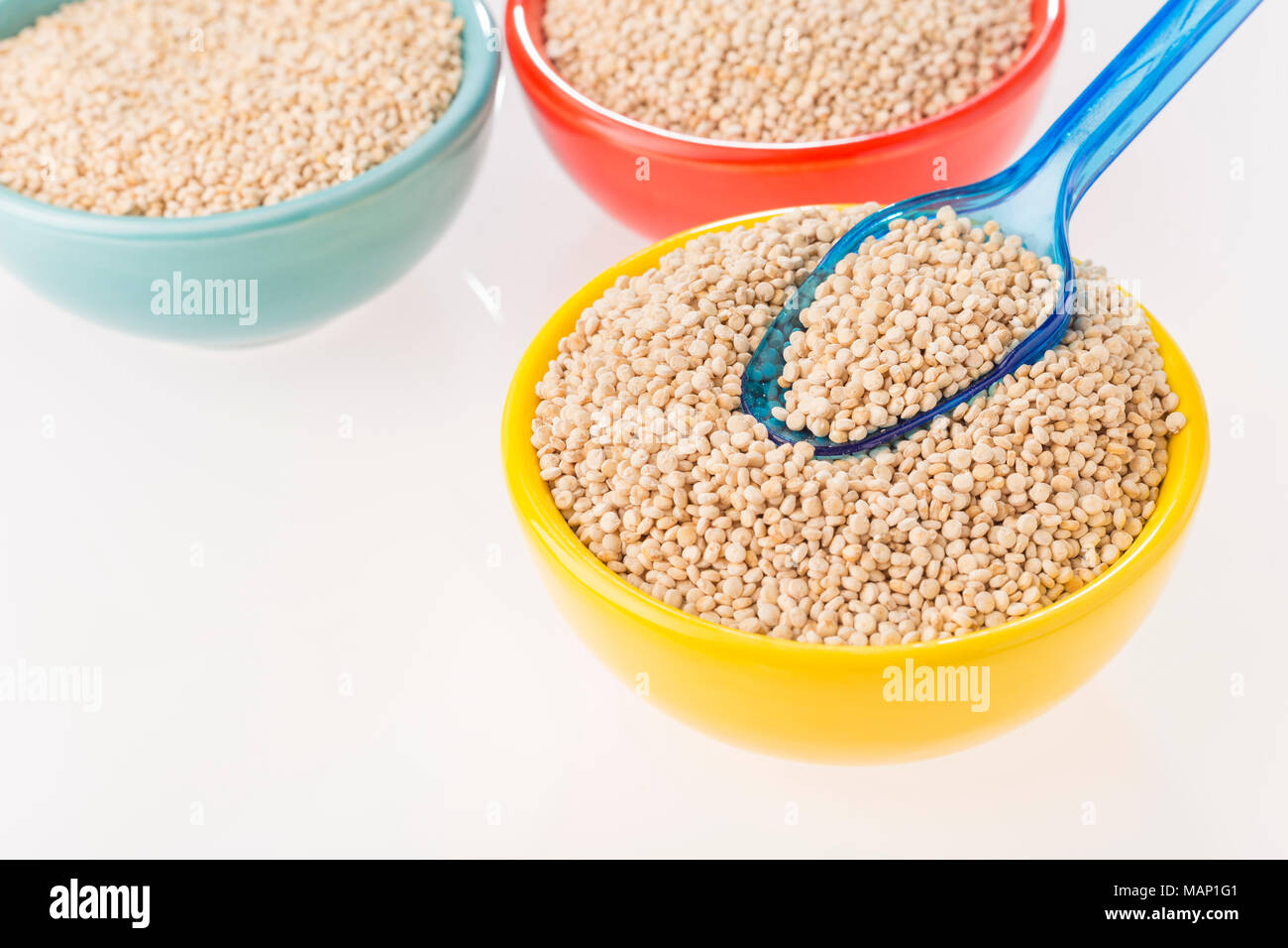Quinoa grains in bowl isolated on white background, Chenopodium quinoa ...