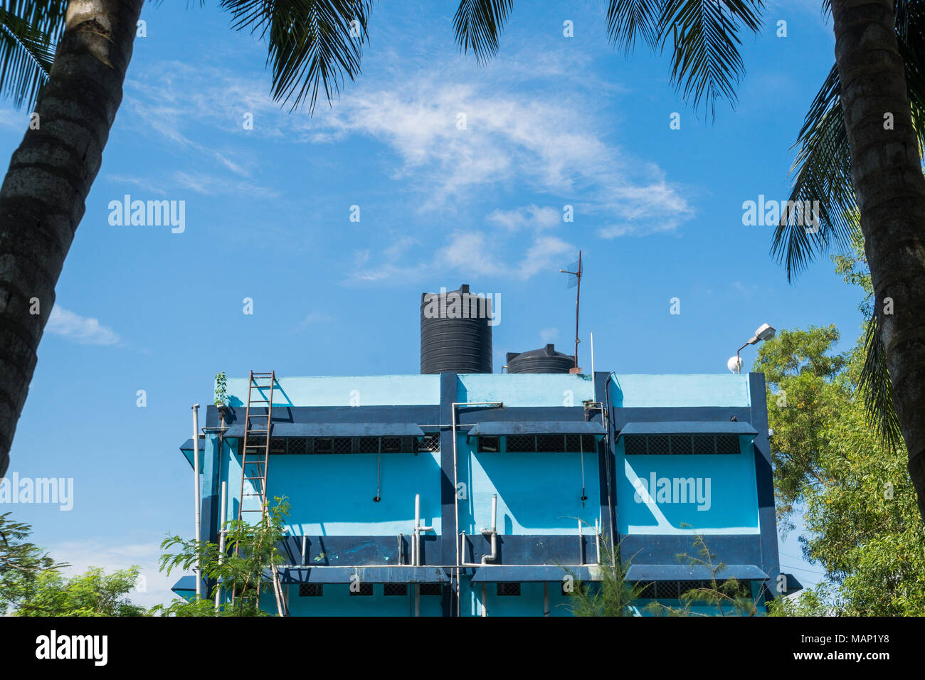 Water tank on the roof over blue sky. Black water tank on the roof of a ...