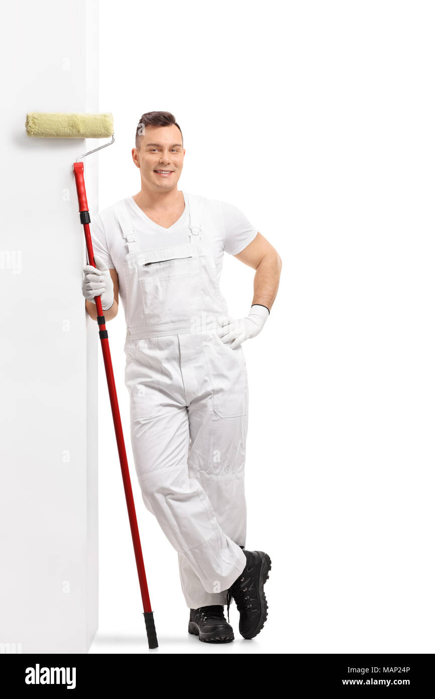 Full length portrait of a painter with a paint roller leaning against a ...