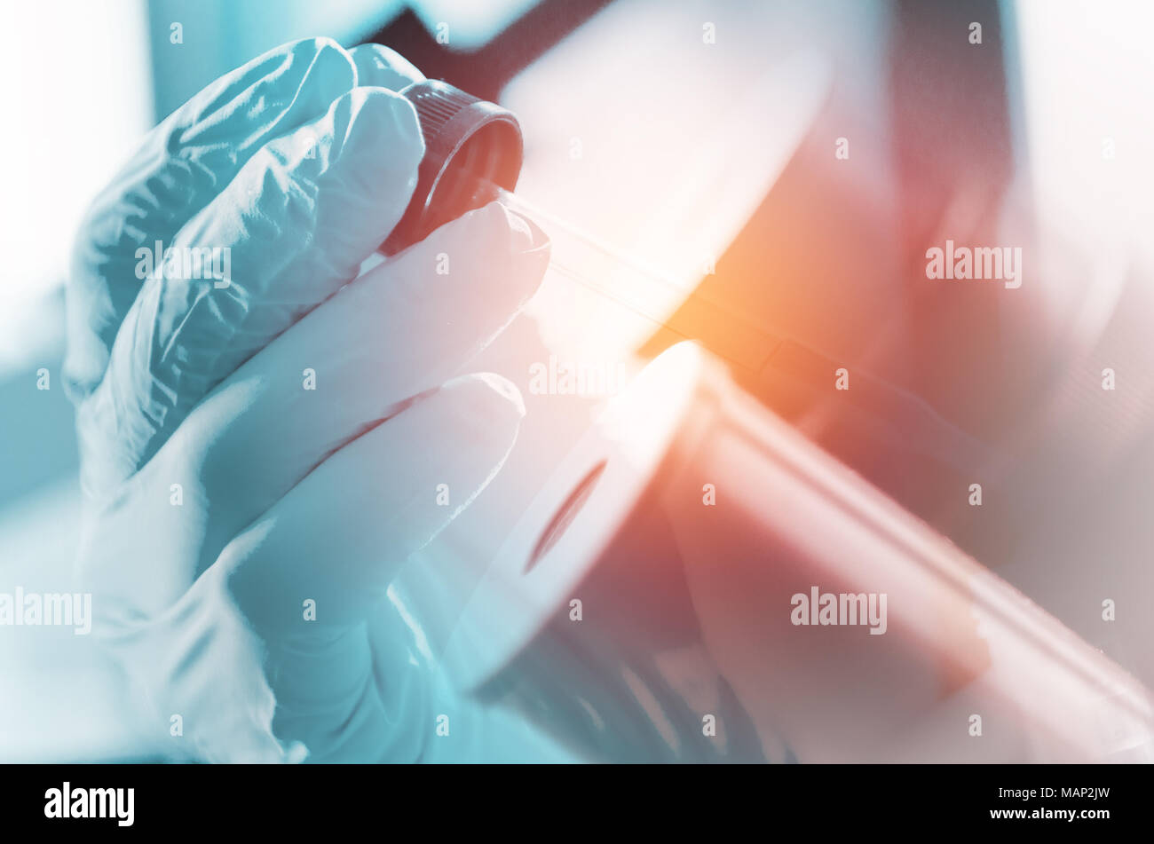 closeup hand of scientist in lab . Hand hold syringe blood in tube ...