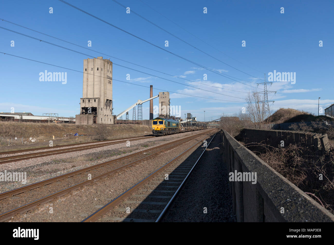 Freightliner class 66 locomotive passing the coke ovens at South Bank ...