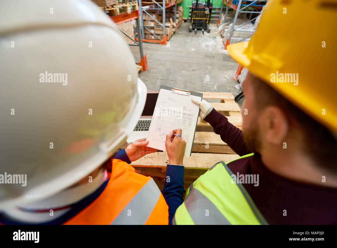 Workers Looking at Plans Stock Photo - Alamy