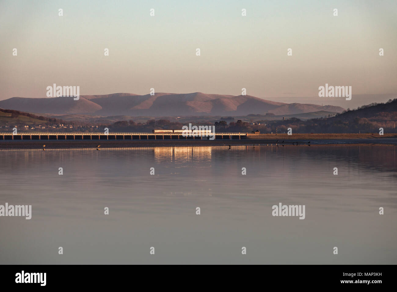 Northern rail sprinter train crossing the river Kent viaduct at Arnside ...