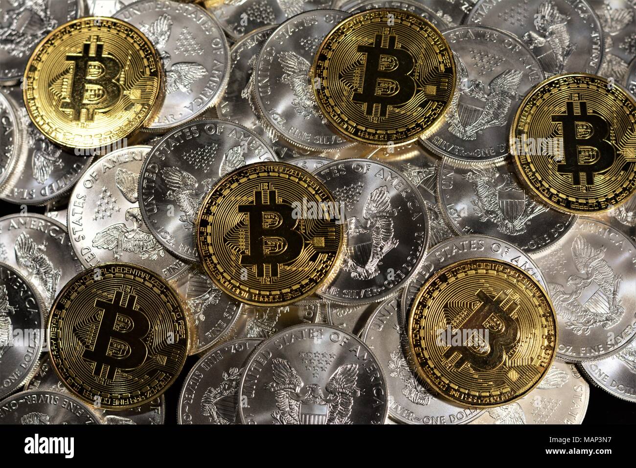 Bit coins with silver dollars and diamonds Stock Photo - Alamy