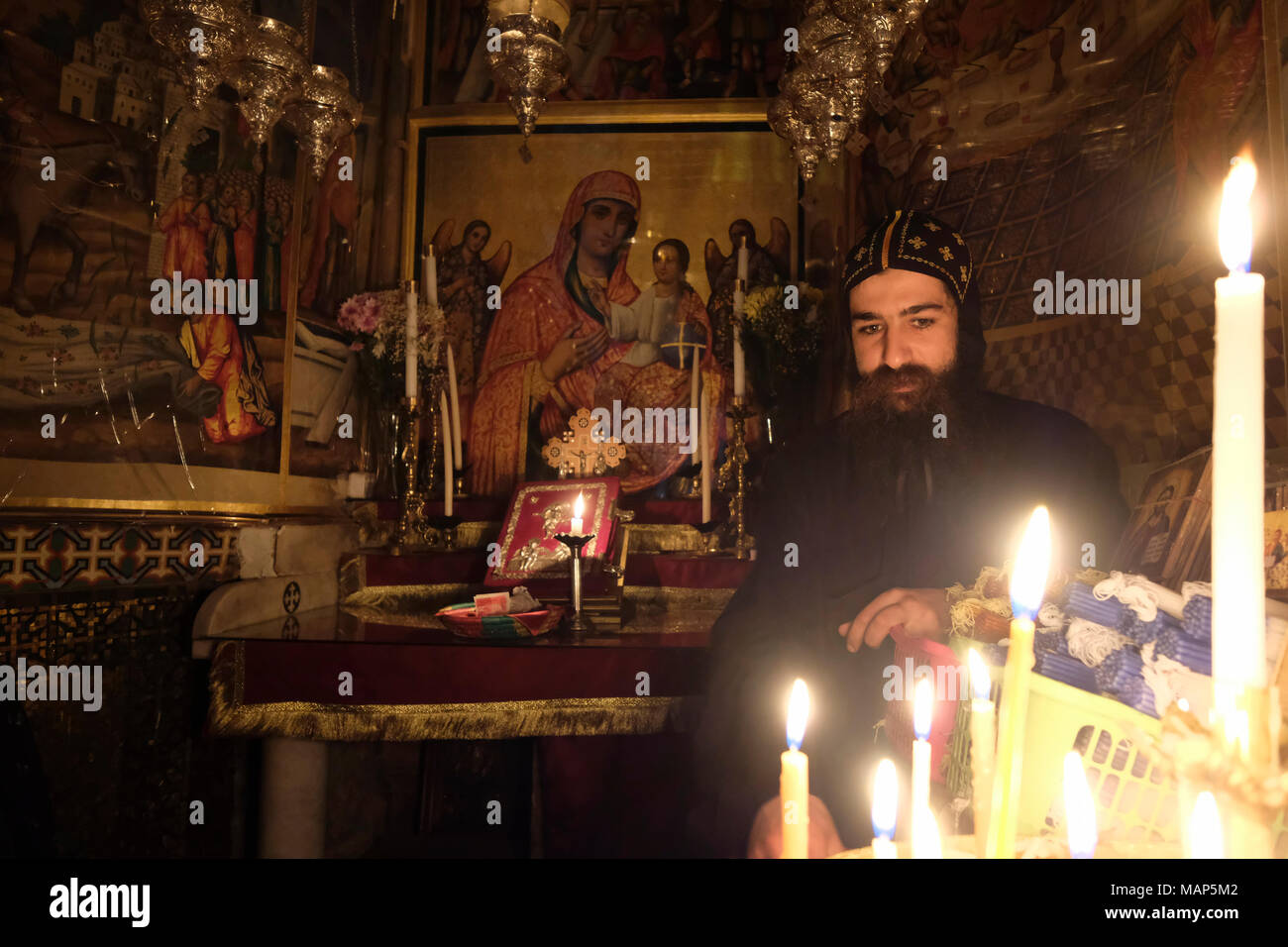 A Coptic Orthodox priest sits inside the small Coptic Chapel which ...