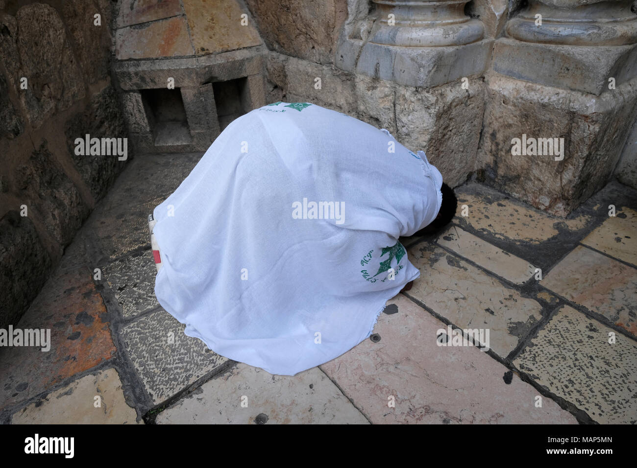 An Ethiopian Orthodox Christian pilgrim bowing in prayer at the ...