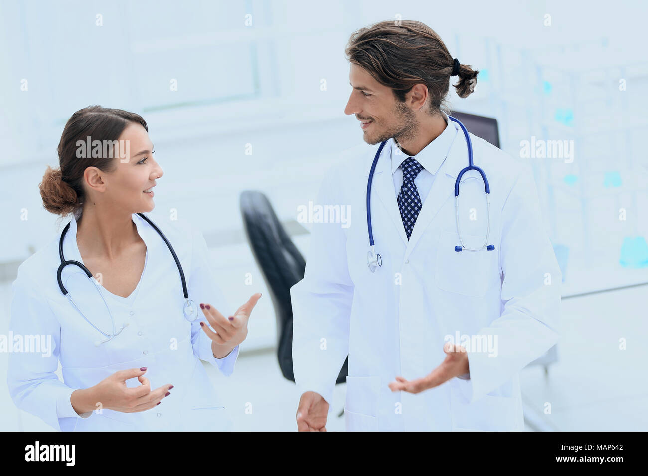 Two Doctors Having Meeting In Hospital Reception Area Stock Photo - Alamy