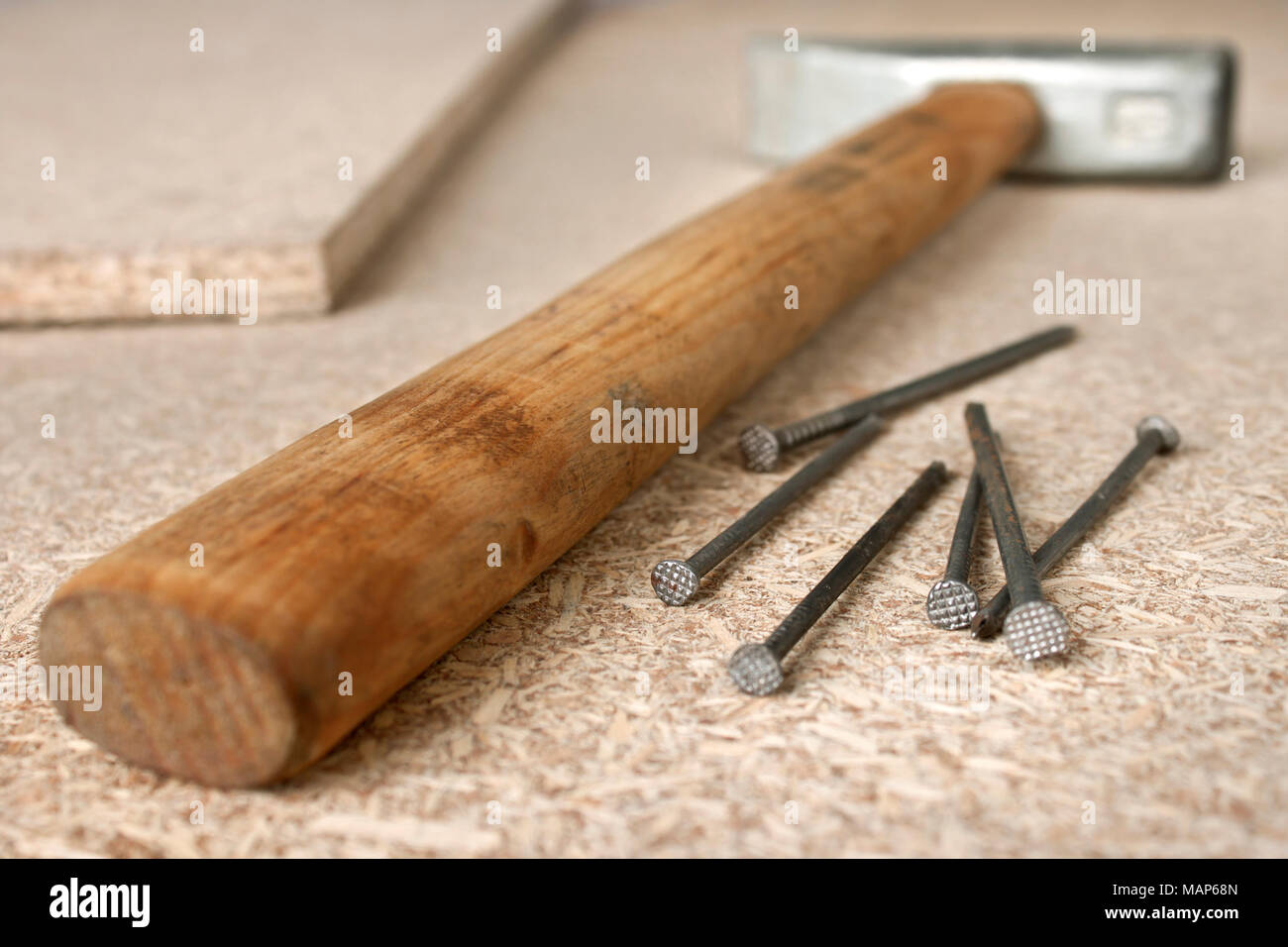 Hammer and a handful of nails are on chipboard Stock Photo - Alamy