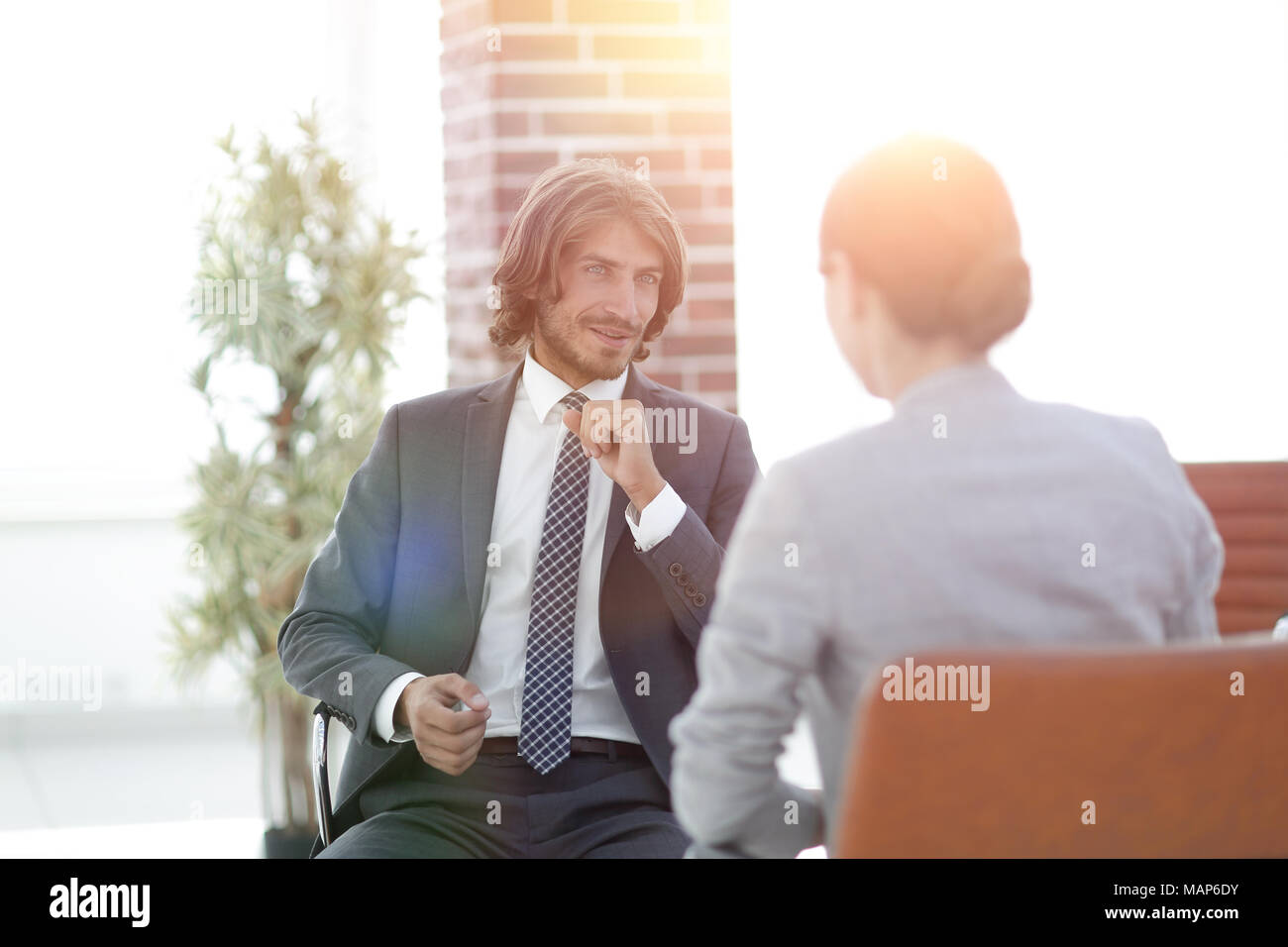 A relaxed conversation of a man and a woman in the office Stock Photo ...