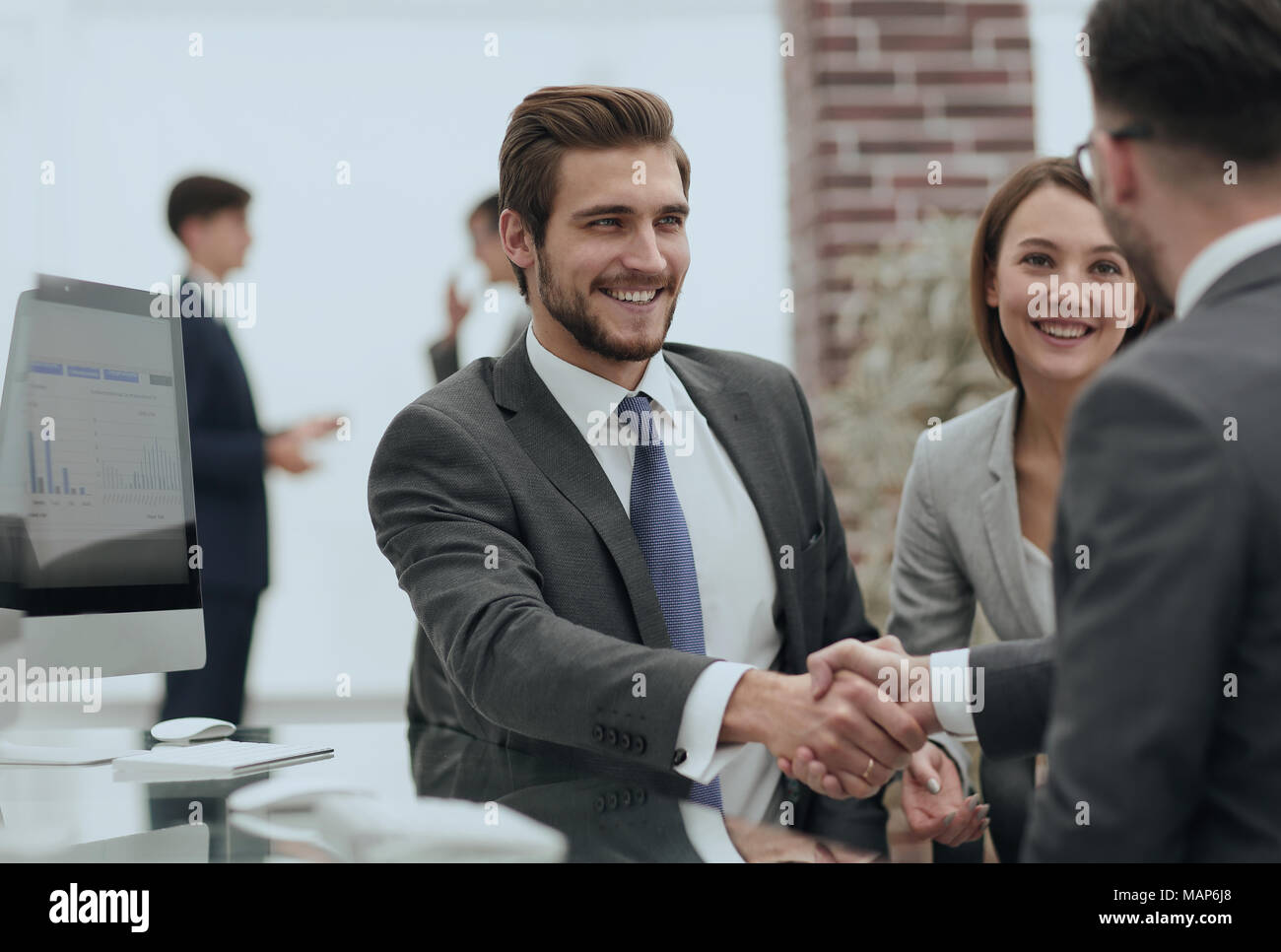 happy man introducing businesswoman to business partners Stock Photo ...