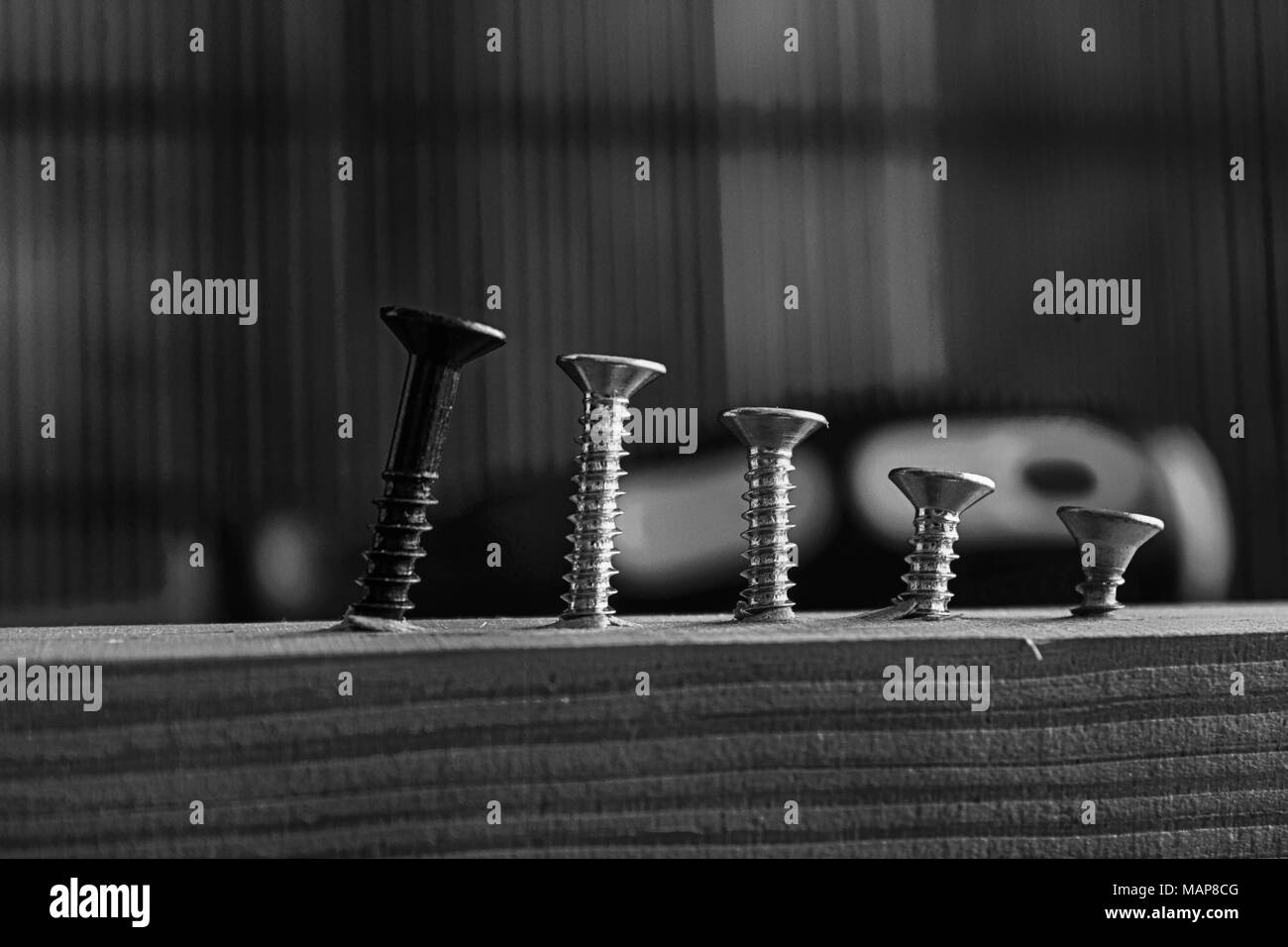 Screwing screw into wooden plank hi-res stock photography and images ...