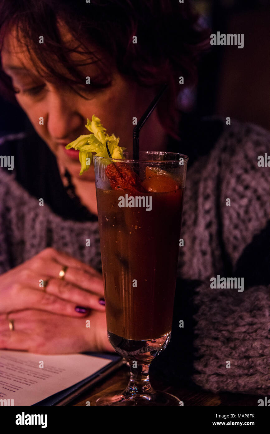Woman reading book with drink, close up Stock Photo - Alamy