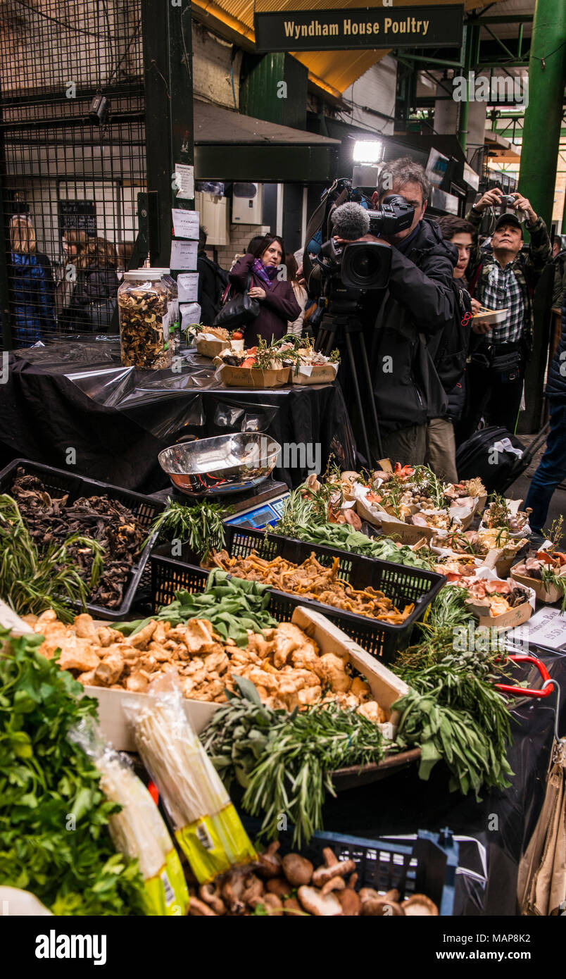 Fresh produce on market stall with camera man, Borough Market ...