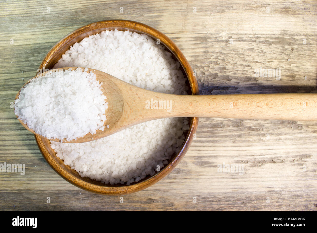 Large sea salt on wooden background Stock Photo - Alamy