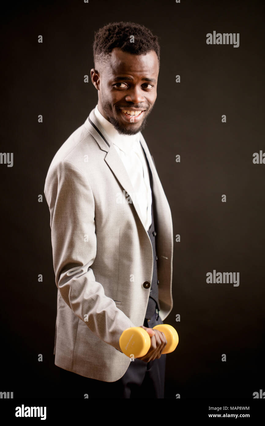 portrait of bodybuilder in formal clothing doing exercises with ...