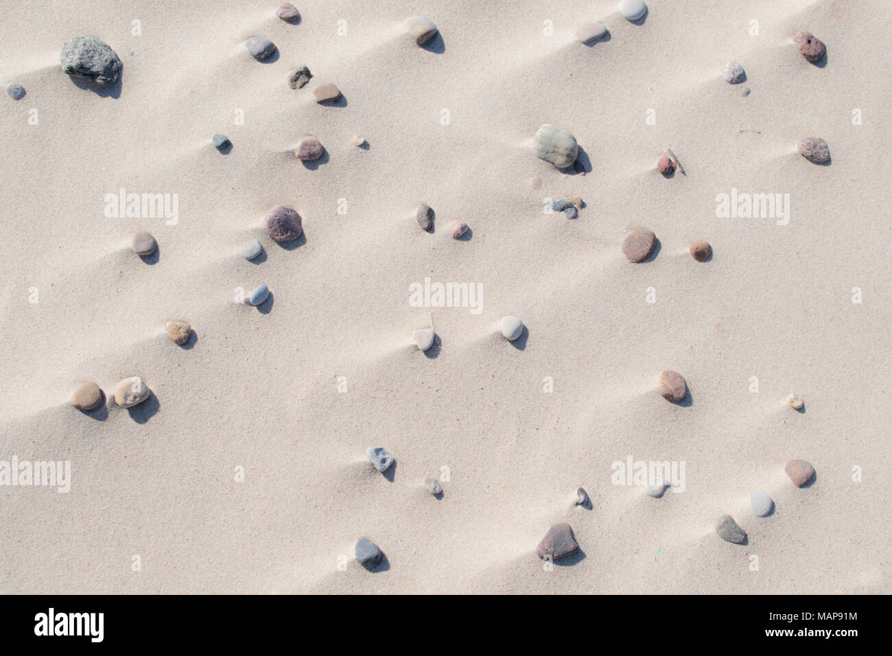 Stones in wind on sand Stock Photo - Alamy