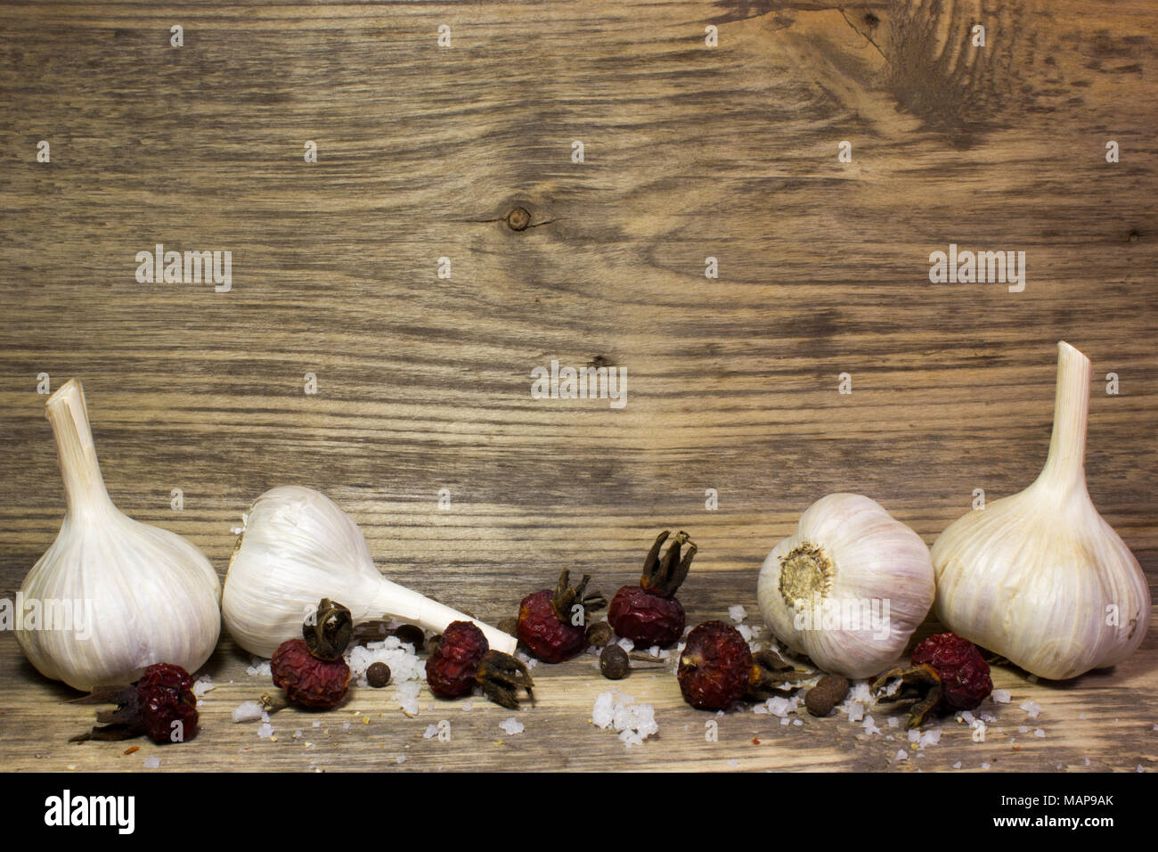Garlic and spices on wooden background. Free space for text Stock Photo ...