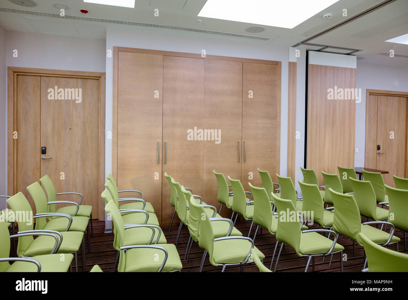 concert hall with stylish green chairs, wooden cabinets and door Stock ...