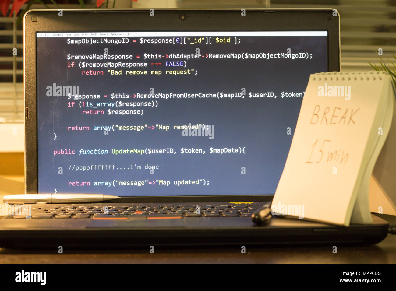 Web developer's workplace. Laptop with a note aside. Break after a hard ...