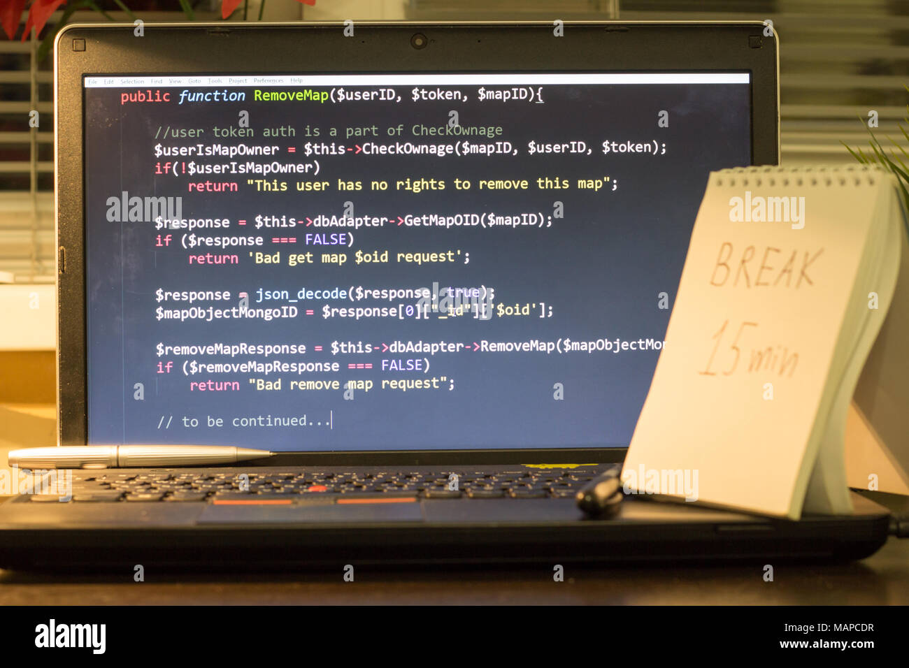 Web developer's workplace. Laptop with a note aside. Break after a hard ...