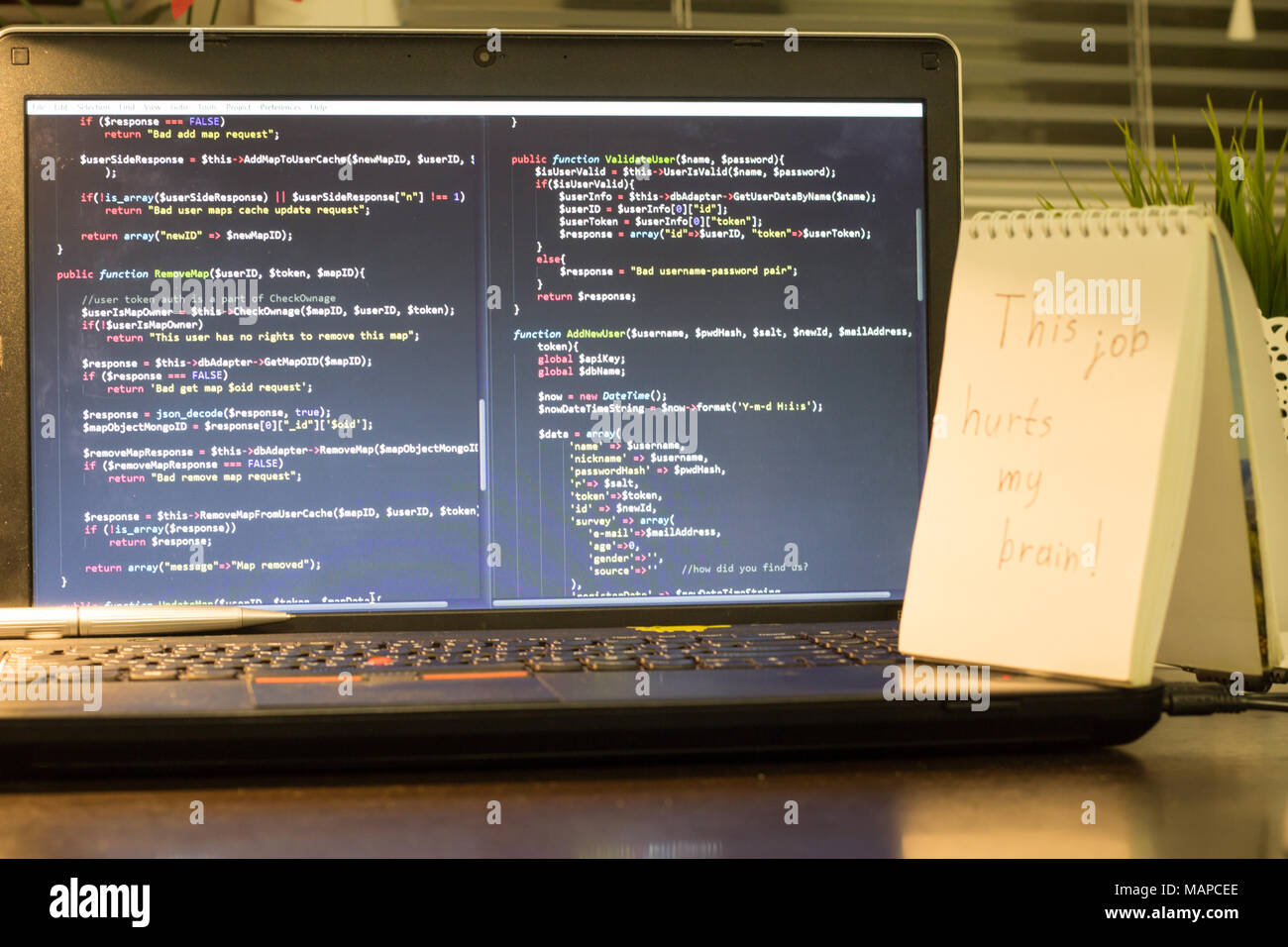 Web developer's workplace. Laptop with a note aside. Break after a hard ...