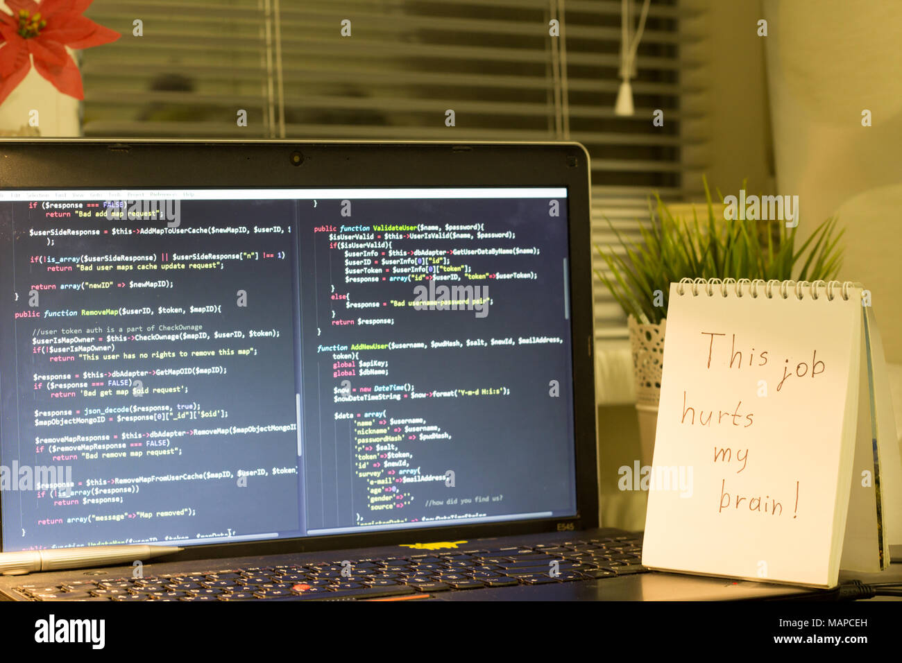 Web developer's workplace. Laptop with a note aside. Break after a hard ...
