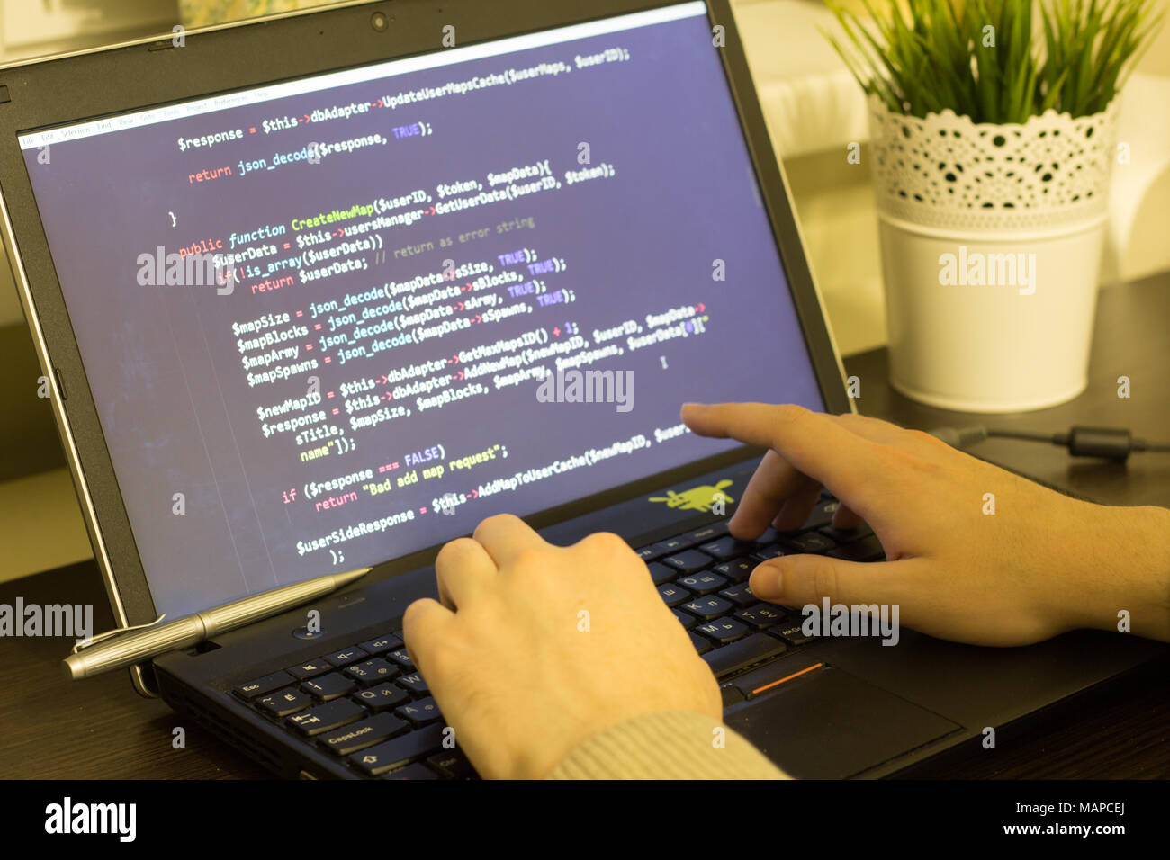 Web developer typing a PHP program on keyboard. Digital technology ...