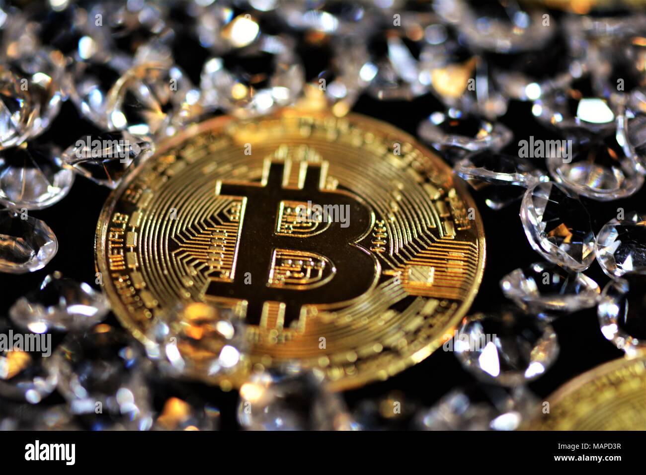 Bit coins with silver dollars and diamonds Stock Photo - Alamy