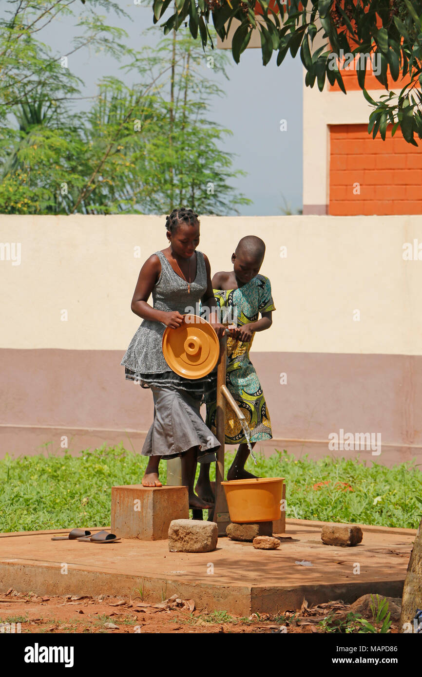 Girls pumping water from the well Stock Photo - Alamy