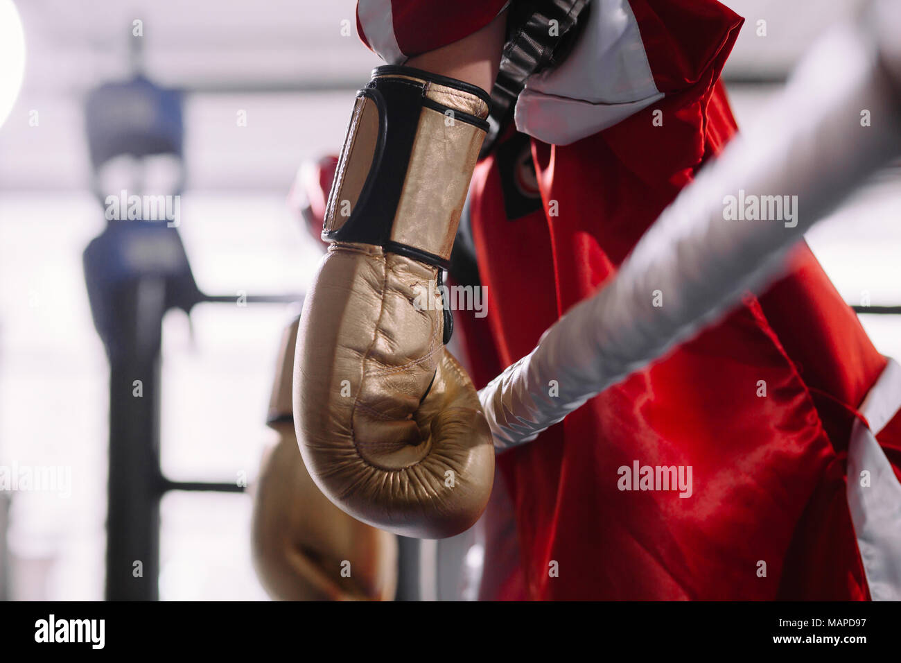 beaten boxer in yellow boxing gloves leaning on ropes Stock Photo - Alamy