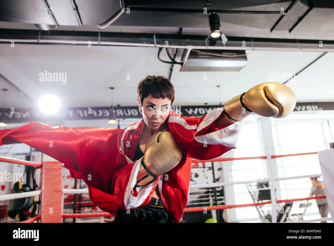 young strong woman hitting straight from the shoulder. awkward blow ...