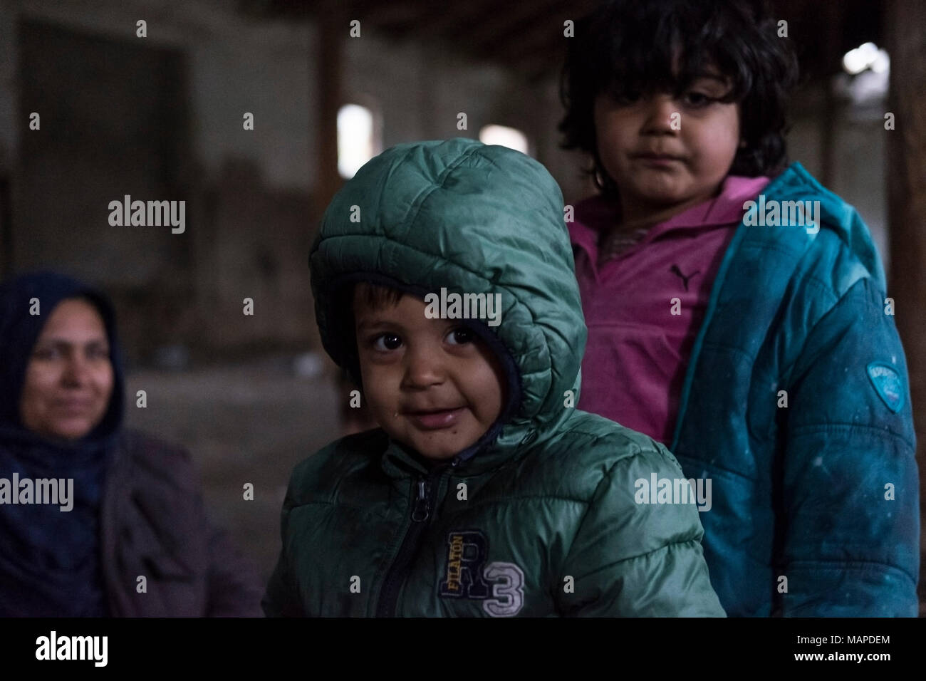 Afghan child refugees smile in an abandoned building next to the ...
