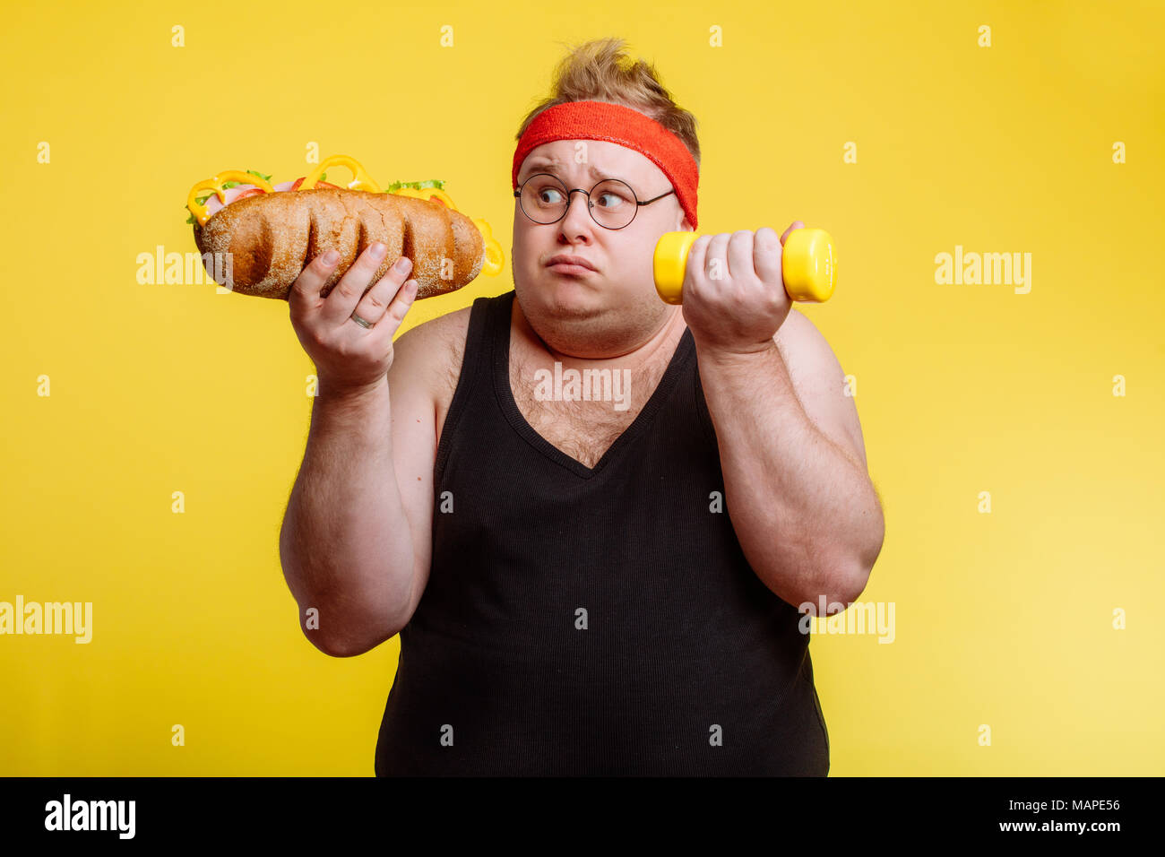 Fat man choise between sport and fastfood Stock Photo - Alamy
