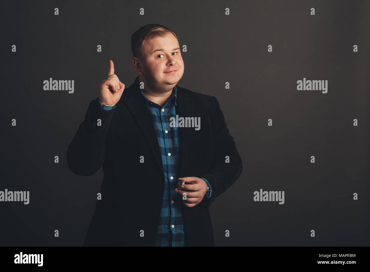 overweight young man pointing up Stock Photo - Alamy