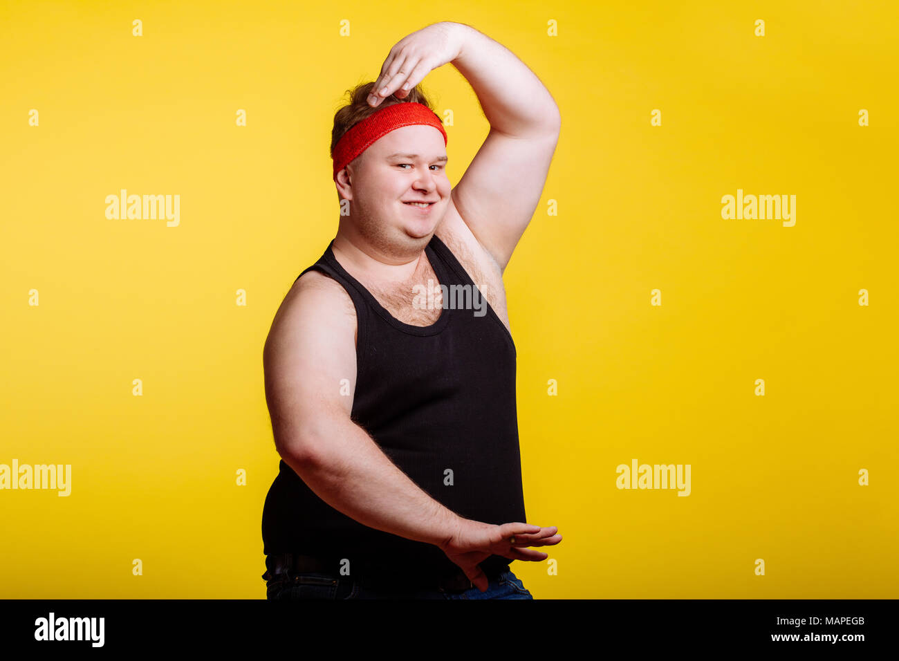 fat man makes kung-fu exercise, rise hands, crane pose Stock Photo - Alamy