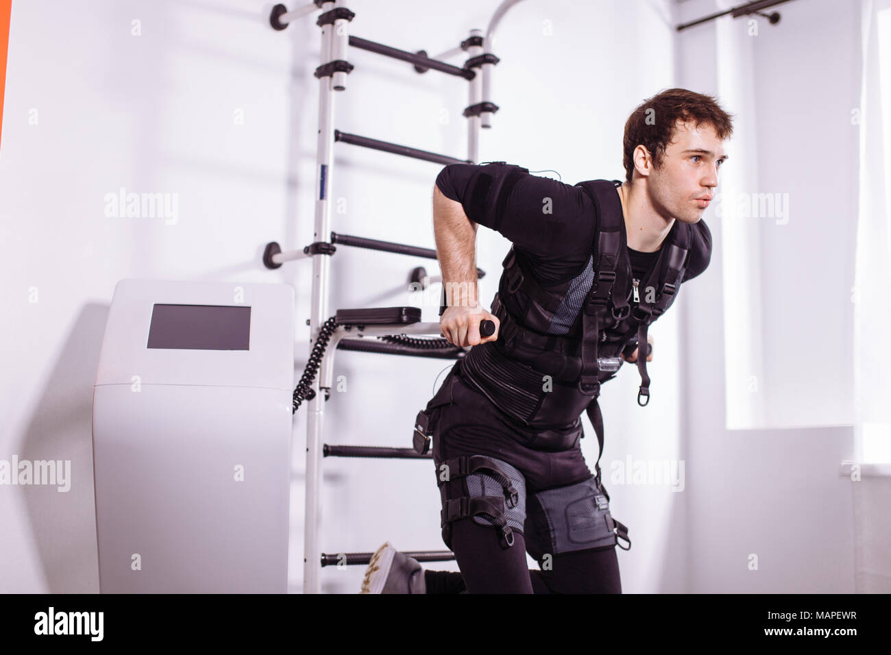 EMS male working out, doing push ups. man doing triceps dips on ...