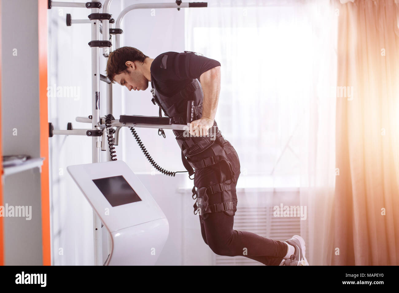 EMS male working out, doing push ups. man doing triceps dips on ...