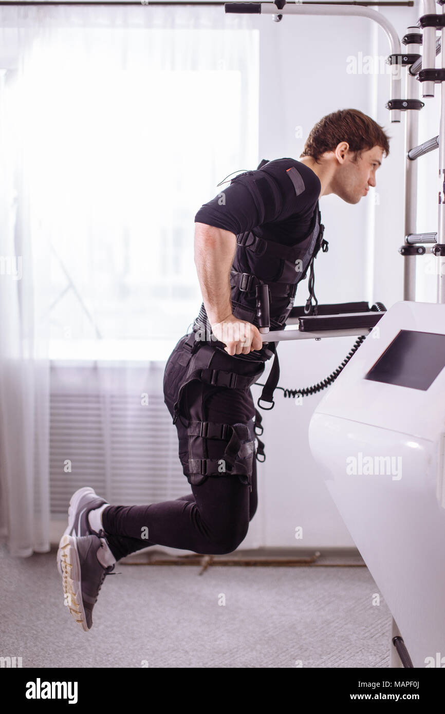 EMS male working out, doing push ups. man doing triceps dips on ...