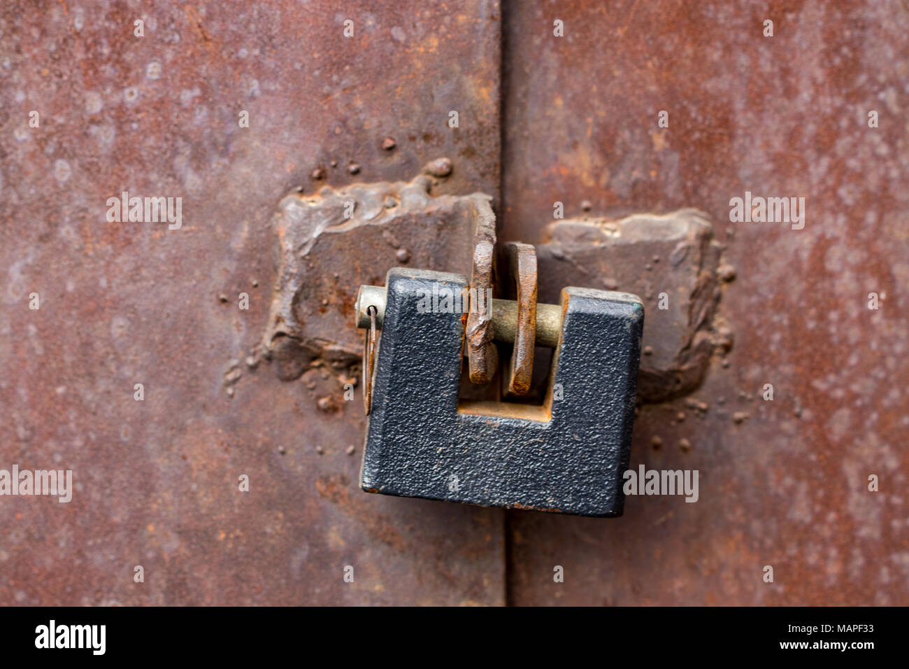 Old locked iron gate with Steel padlock, Close up Stock Photo - Alamy