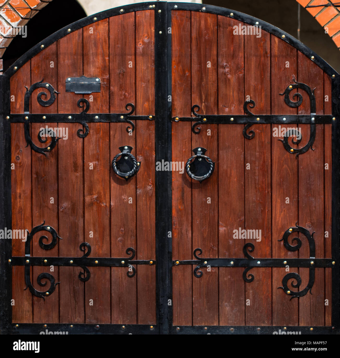 Old Wooden gate with metal decoration close up Stock Photo - Alamy