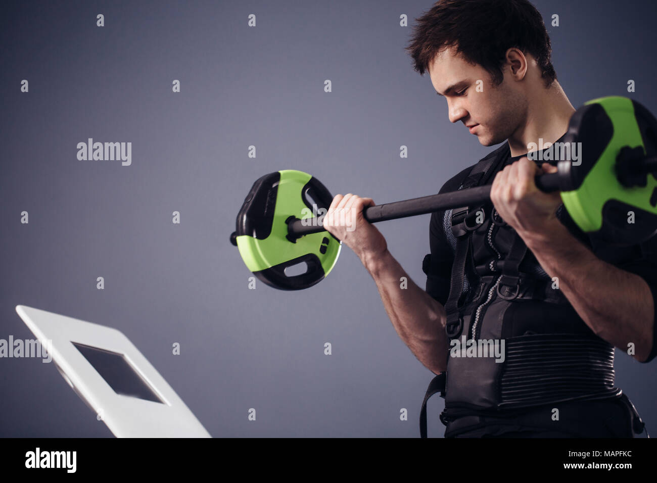 Man working out EMS training with barbell closeup, power pose Stock ...