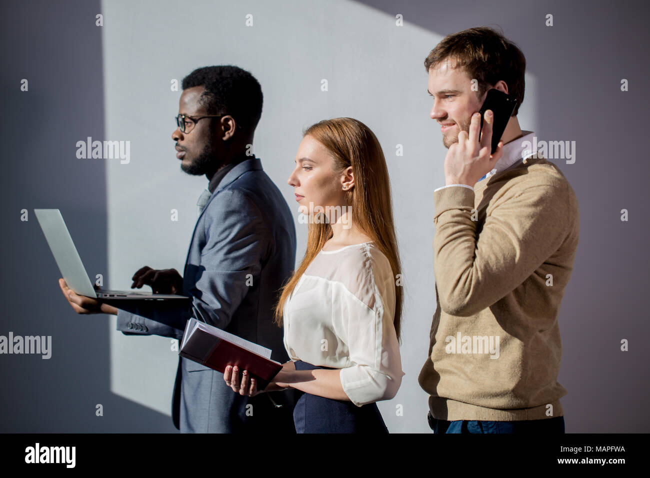 Business people together in meeting room with phone, notepad and laptop ...