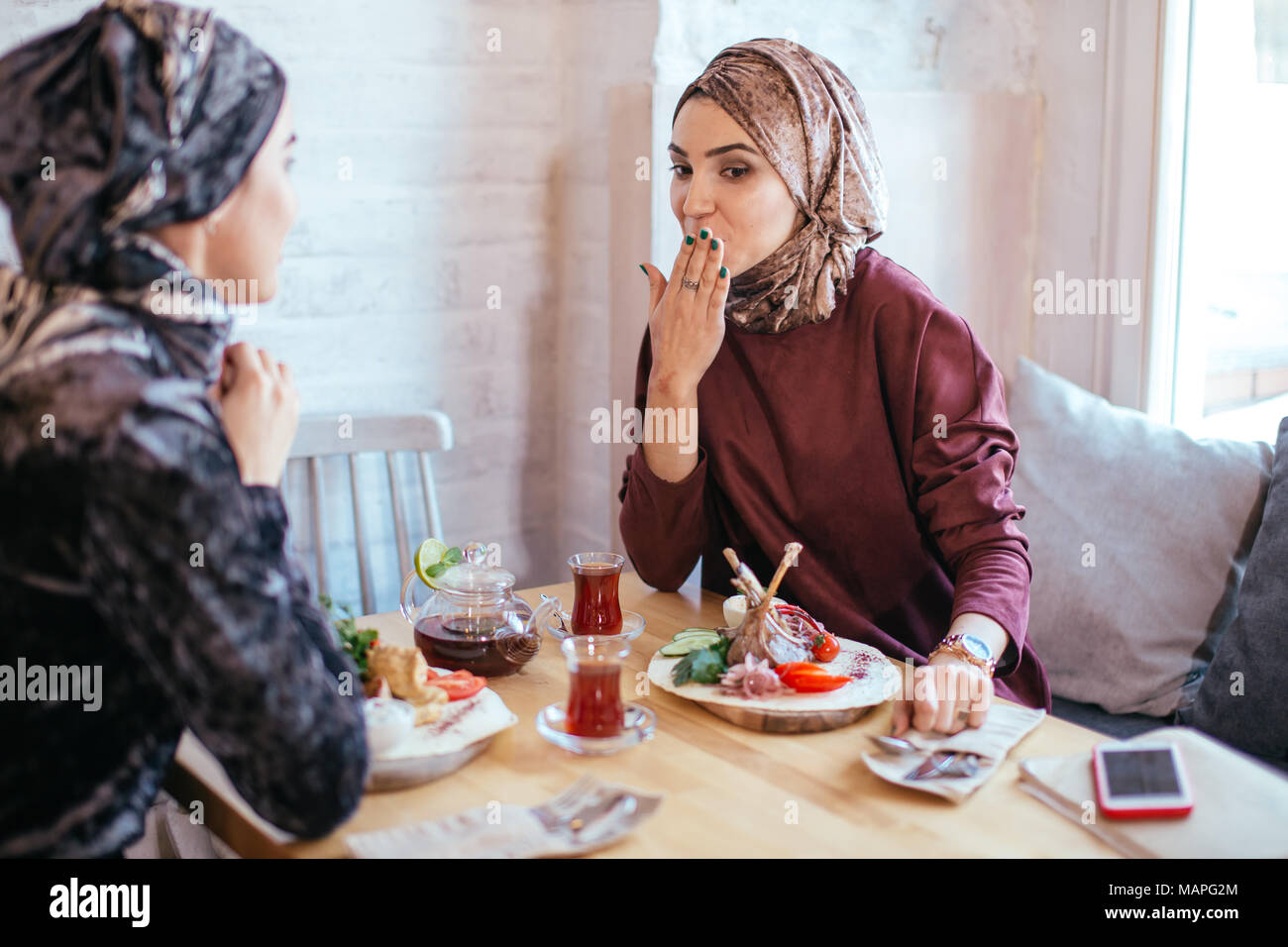 Two Muslim women in cafe, friends meeting Stock Photo - Alamy