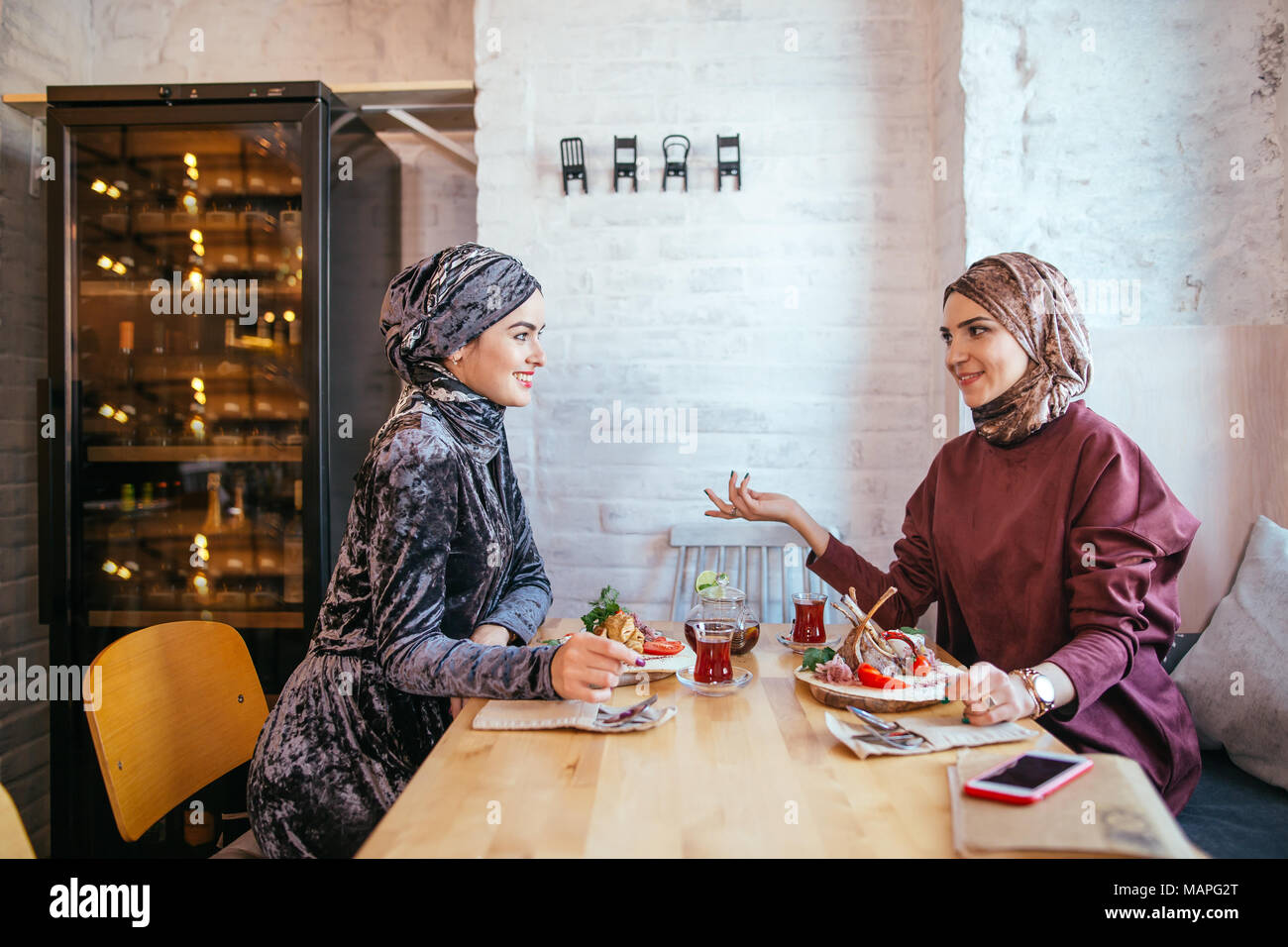 Two Muslim women in cafe, friends meeting Stock Photo - Alamy