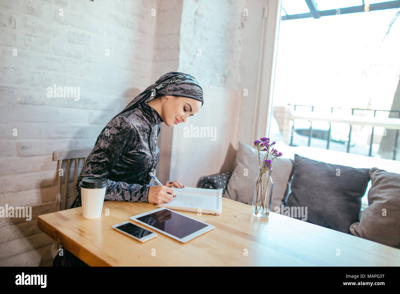 Cheerful muslim lady in cafe hi-res stock photography and images - Alamy